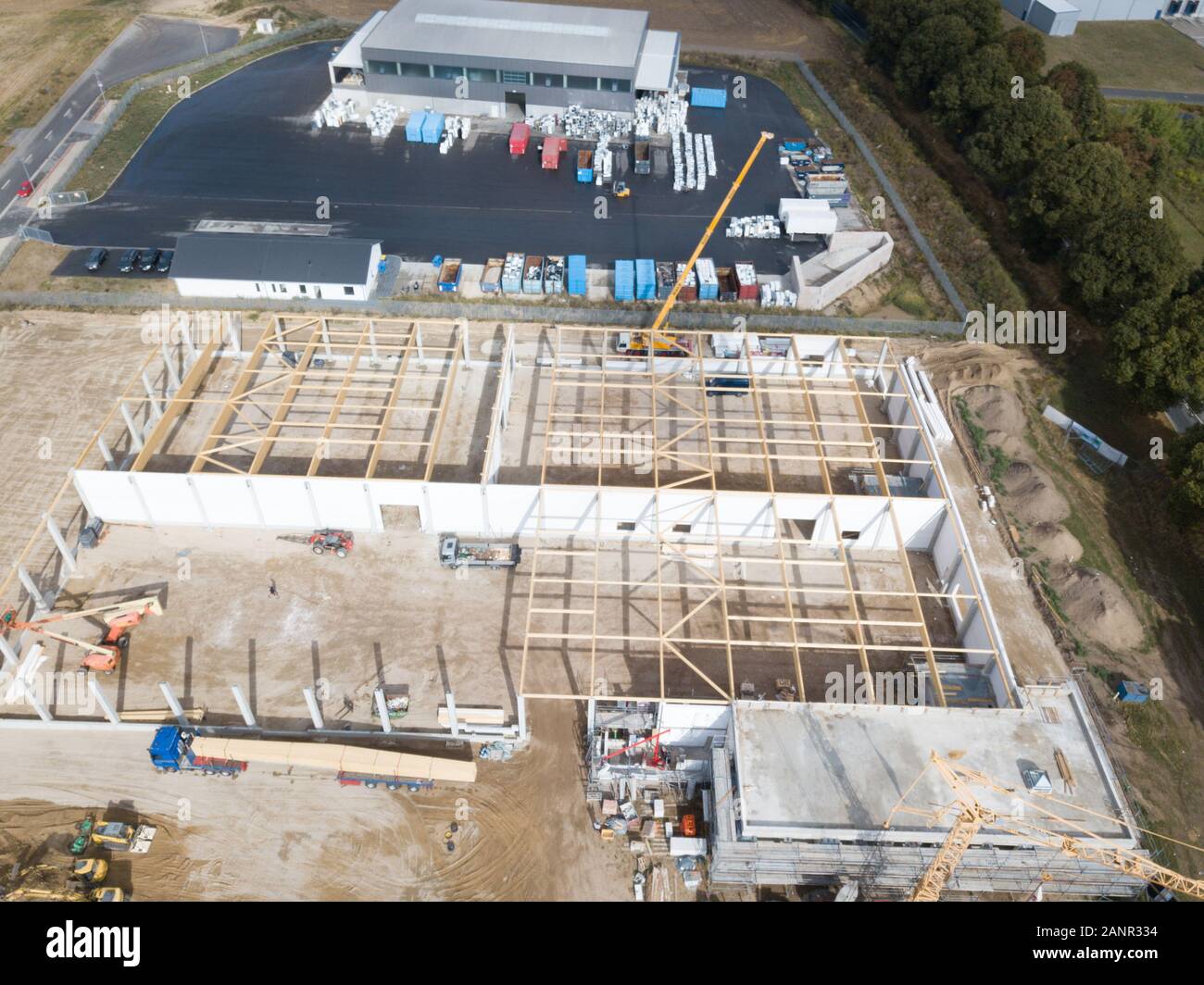 on a building site wooden trusses are built on the concrete columns of ...