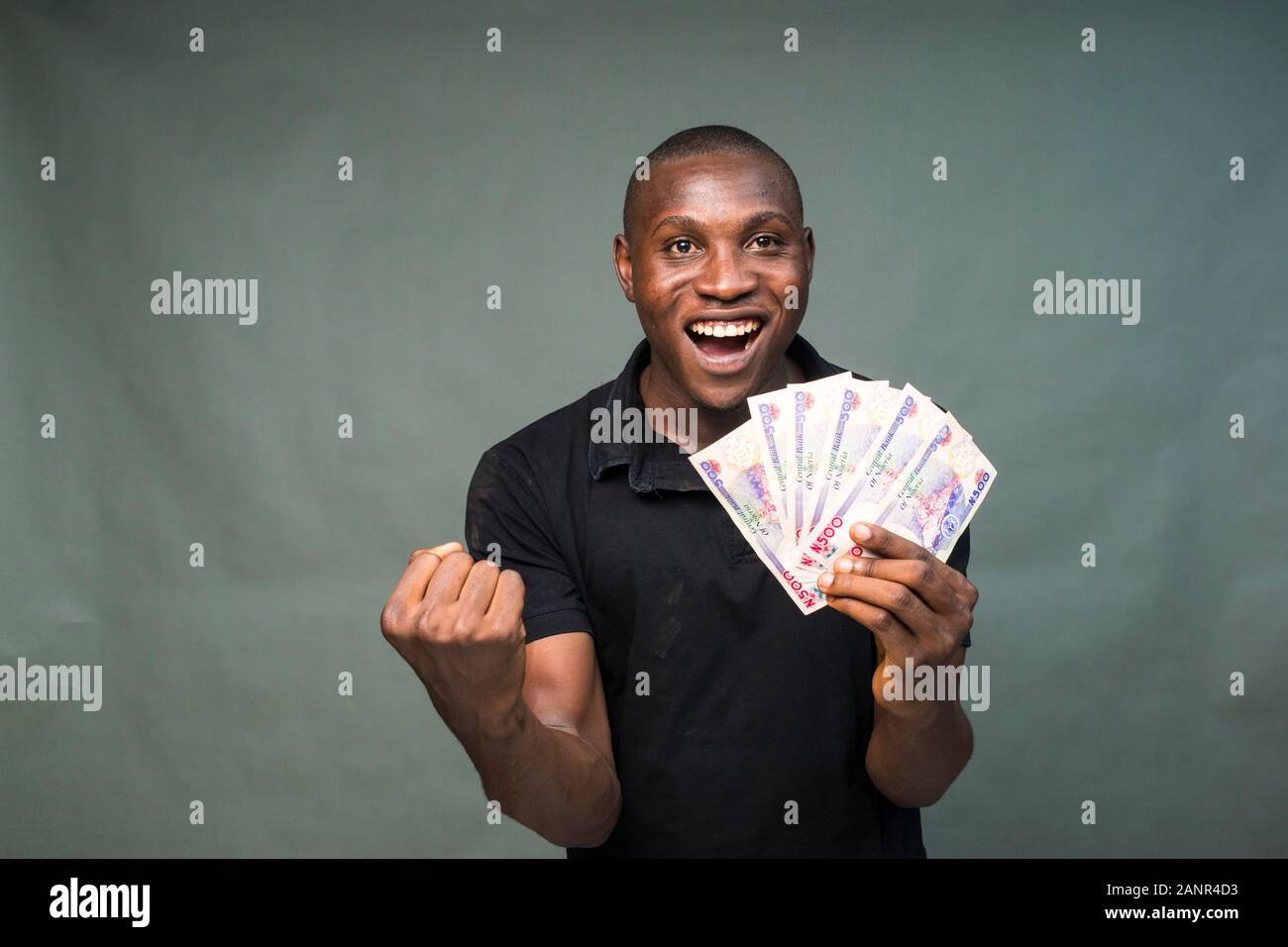 young black man holding some cash, feeling excited and celebrates Stock ...