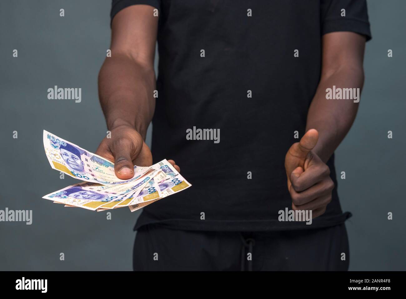 African holding cash hi-res stock photography and images - Alamy