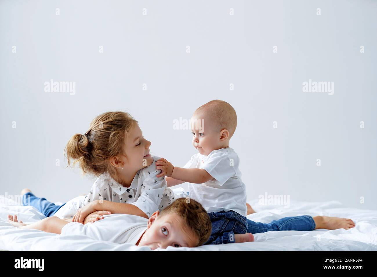 Brother And two sisters Relaxing, Have Fun Together In Bed Stock Photo ...
