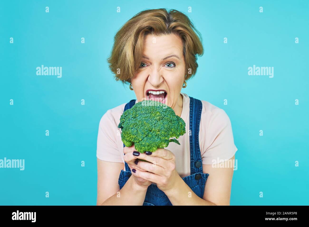 An aged woman is about to eat a vegetarian dish. Funny old woman on a ...