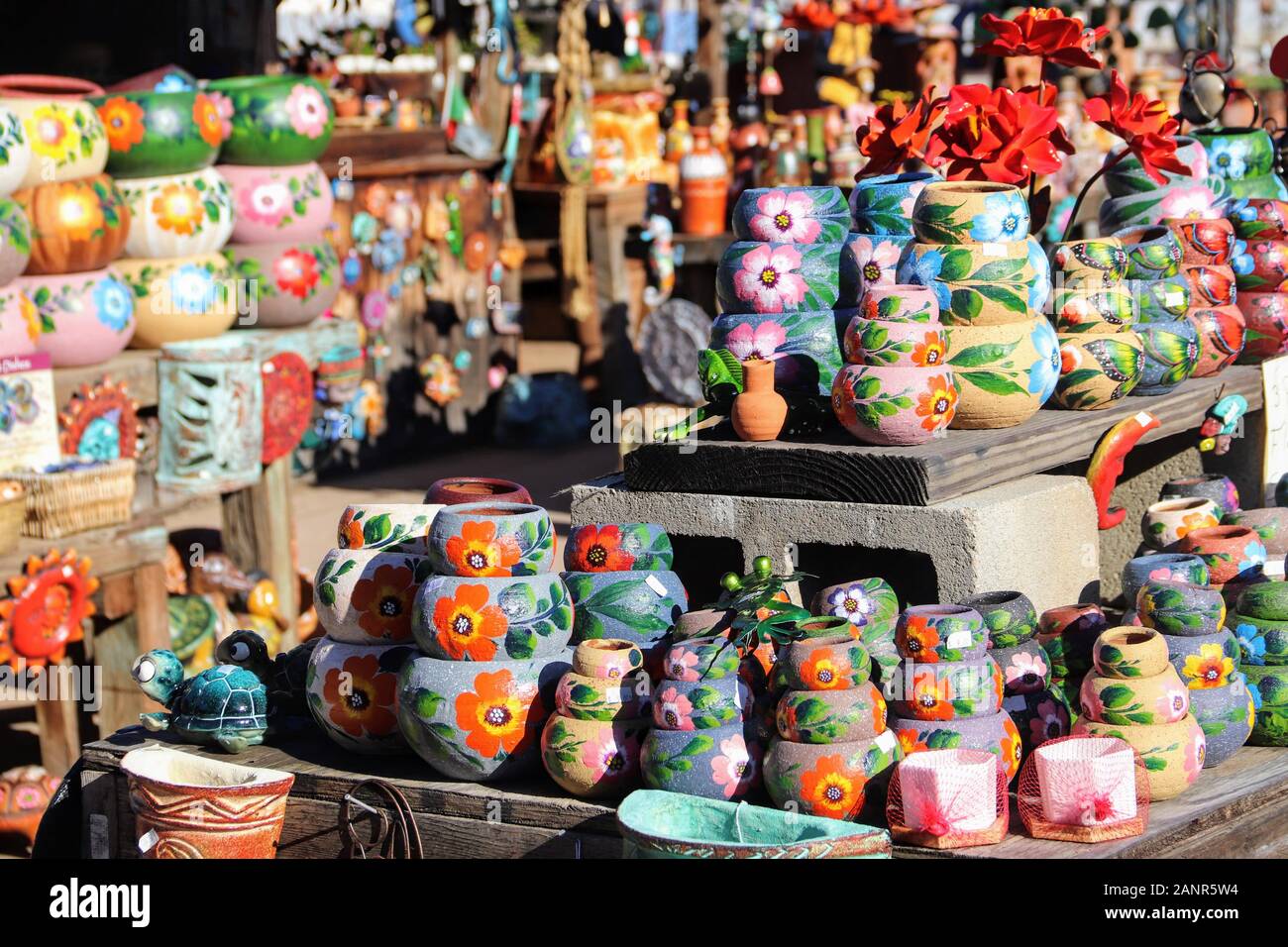Bright colorful Mexican pottery stacked on display for sale Stock Photo ...