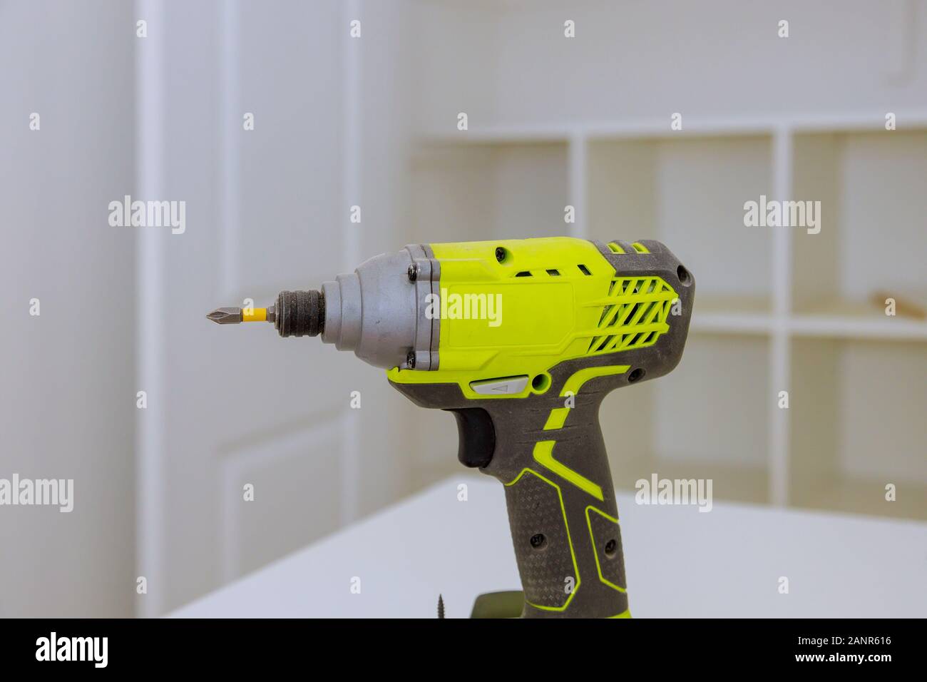 Electric cordless screwdriver drill construction tools on wooden desk ...