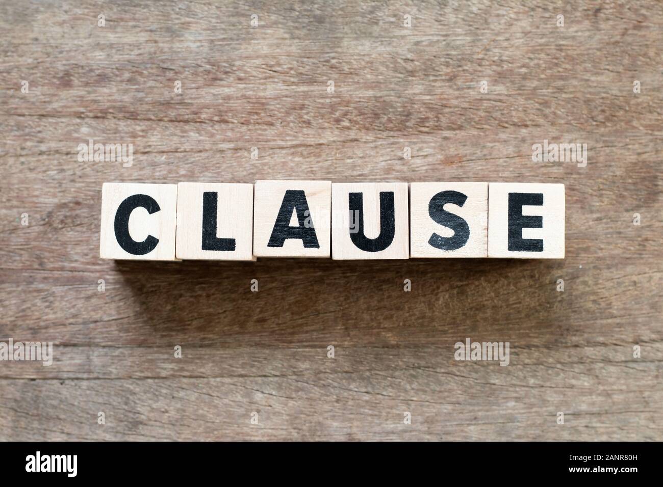 Letter block in word clause on wood background Stock Photo - Alamy
