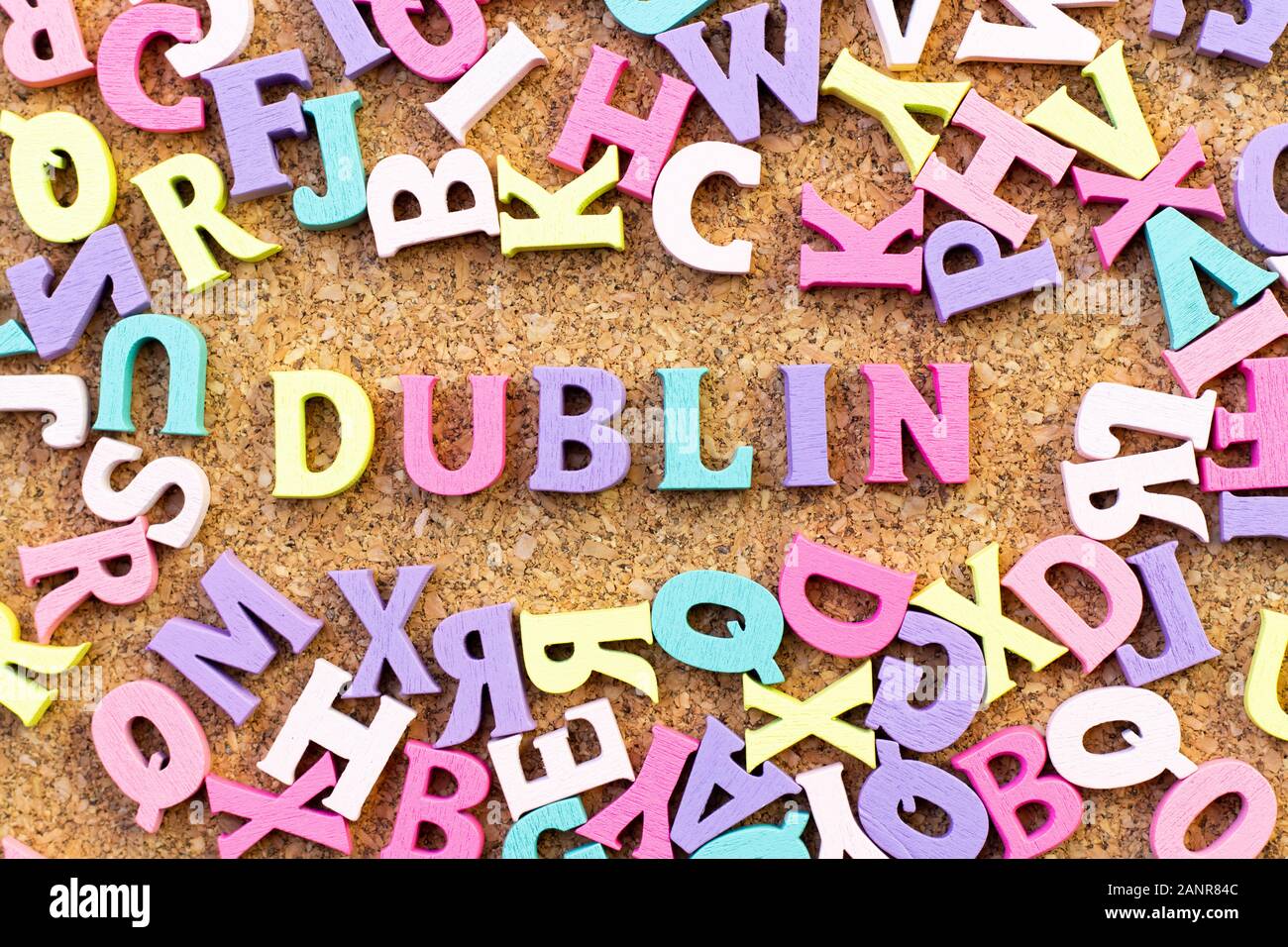 Color alphabet in word Dublin with another letter as frame on cork ...