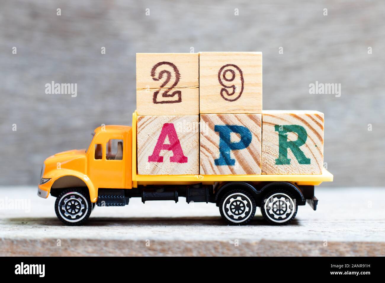 Truck hold letter block in word 29apr on wood background (Concept for ...