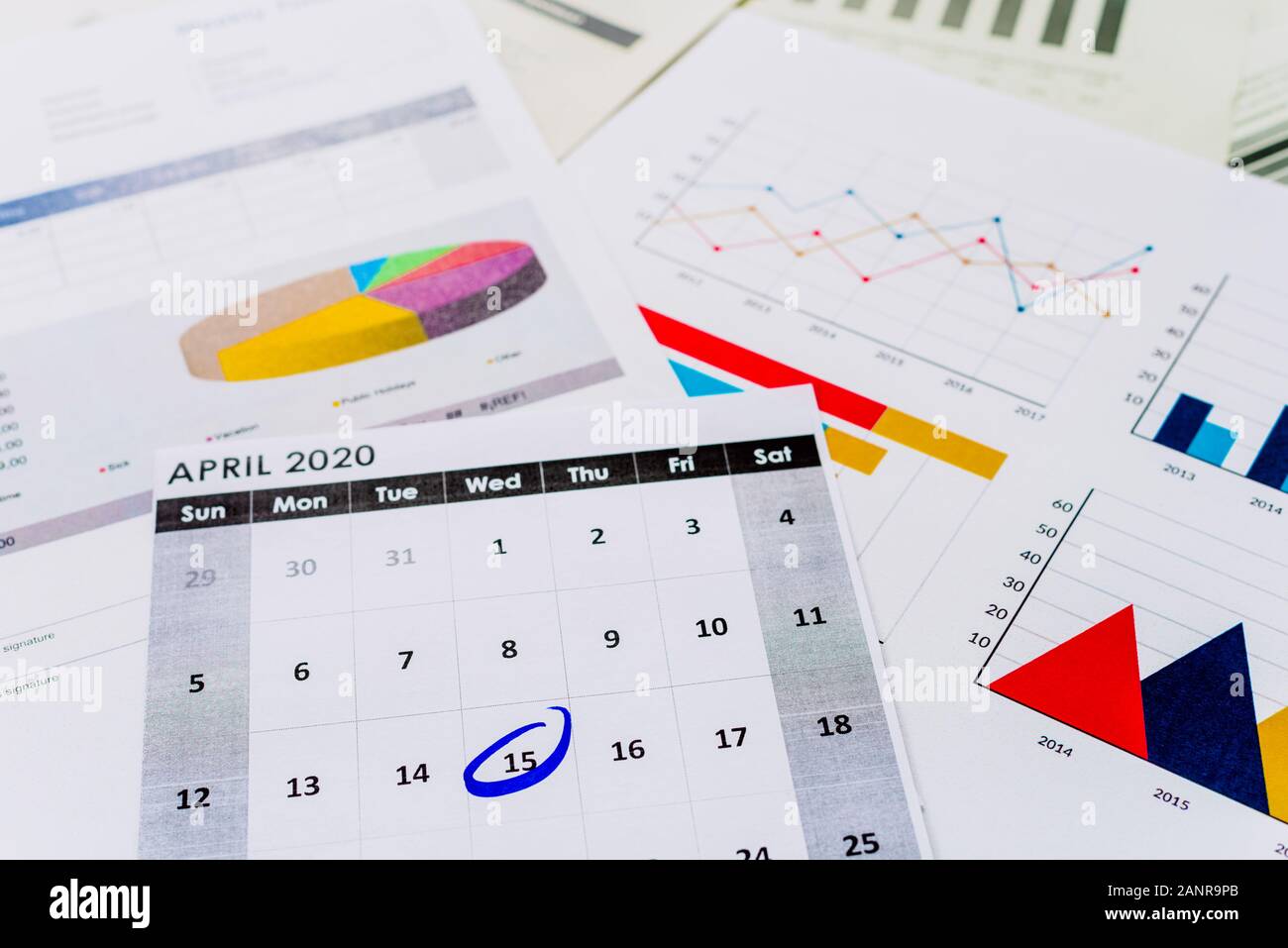 Calendar with April 15, 2020 marked as tax payment day and charts ...