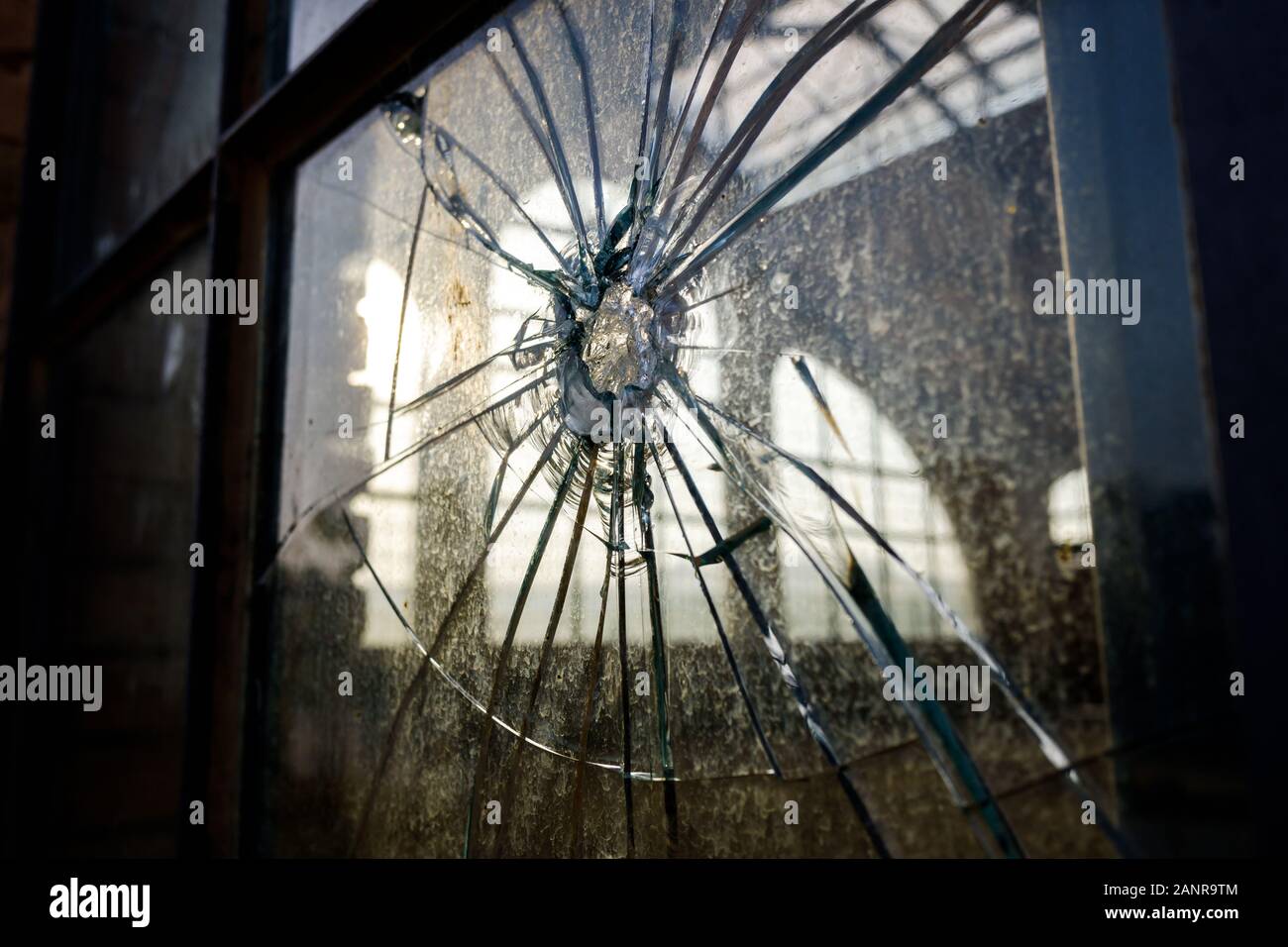 Vandals shatter glass of a window with stones Stock Photo - Alamy