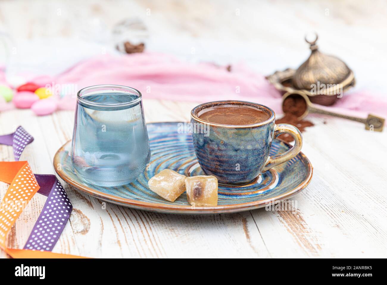Traditional turkish coffee in porcelain cup set,a glass of water and ...