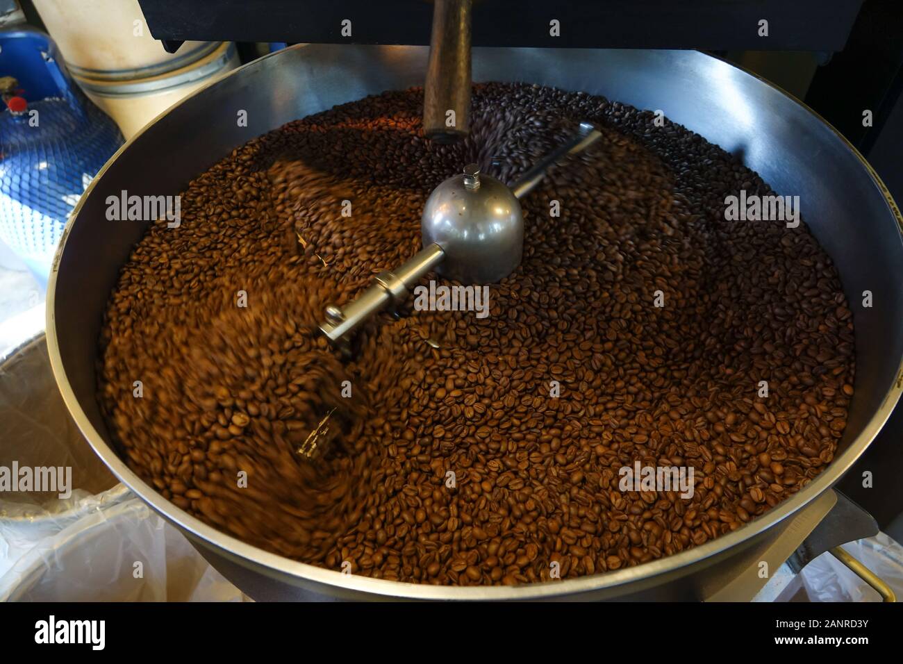 Coffee roaster machine in action mixing the beans Stock Photo - Alamy