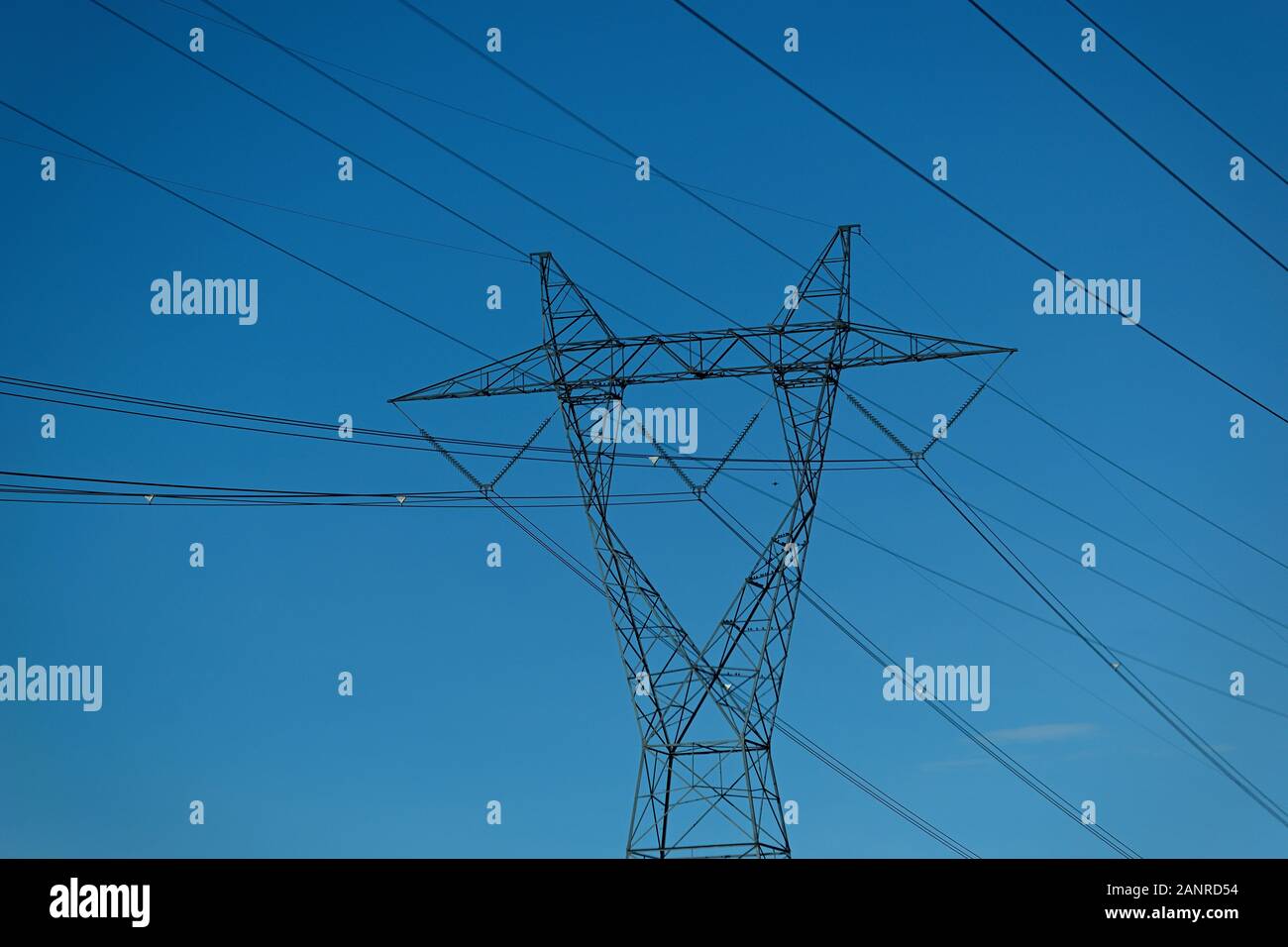 High voltage electricity power lines and intricate tower/transmission ...