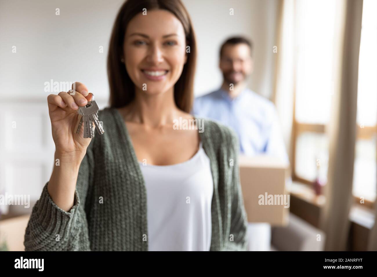 Young woman show house keys excited to move in Stock Photo - Alamy