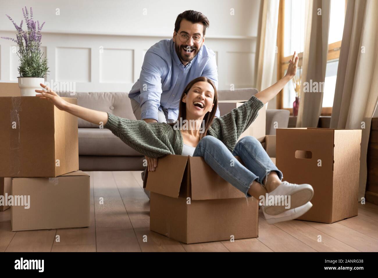 Happy couple having fun unpacking hi-res stock photography and images ...