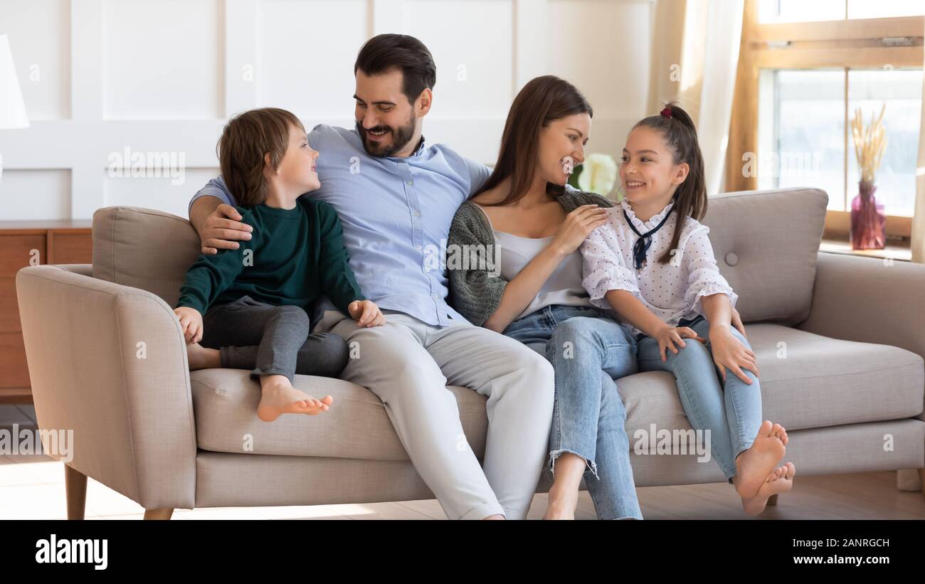 Happy parents enjoy weekend at home with small kids Stock Photo - Alamy