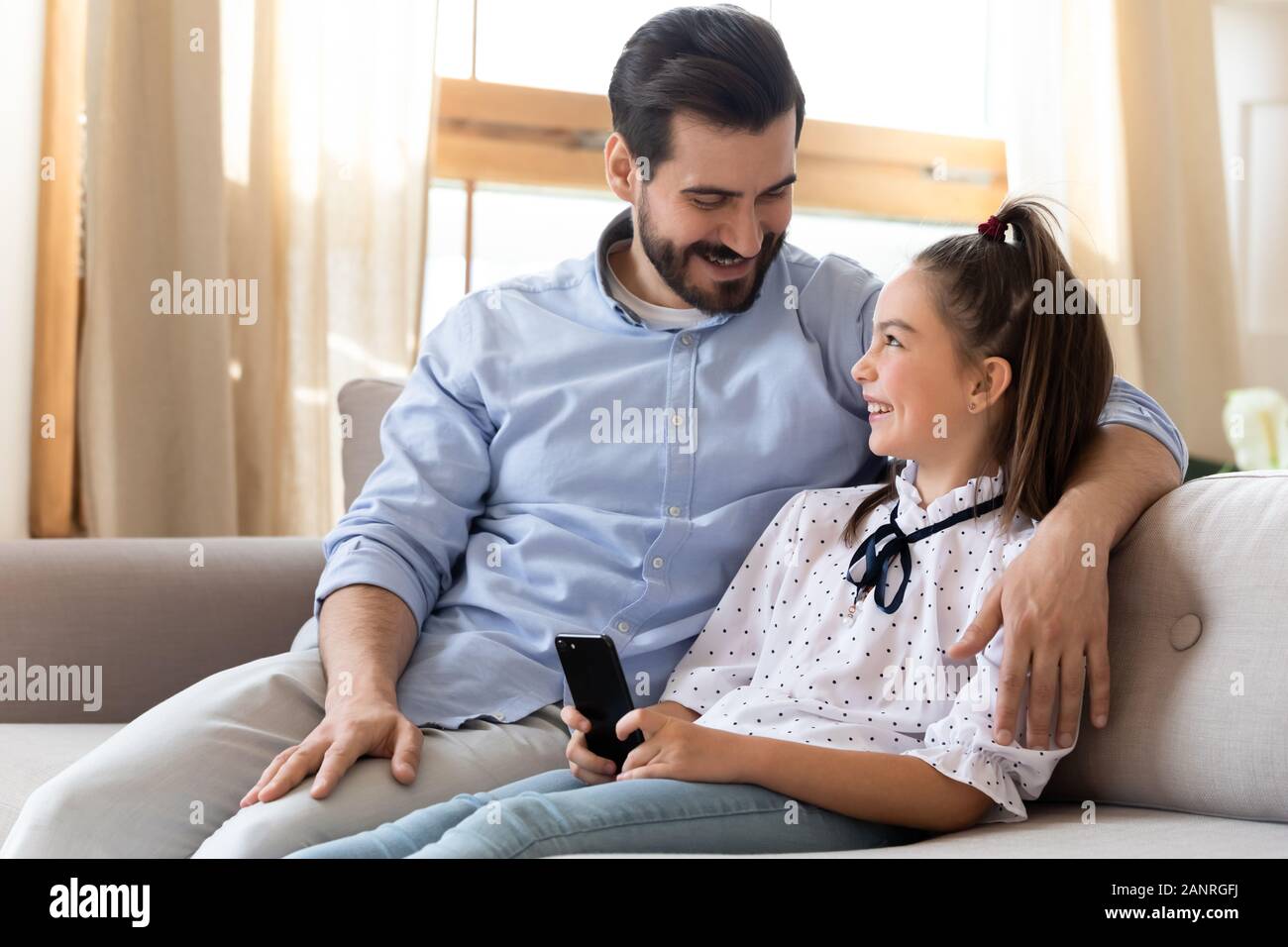 Happy father enjoy weekend with daughter using cell Stock Photo - Alamy