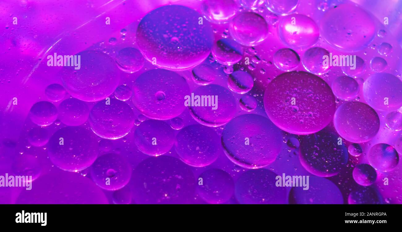 purple cooking oil bubbles in water.abstract textured background ...