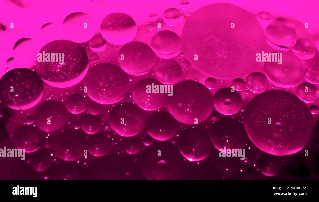 pink color cooking oil bubbles in water.abstract textured background ...