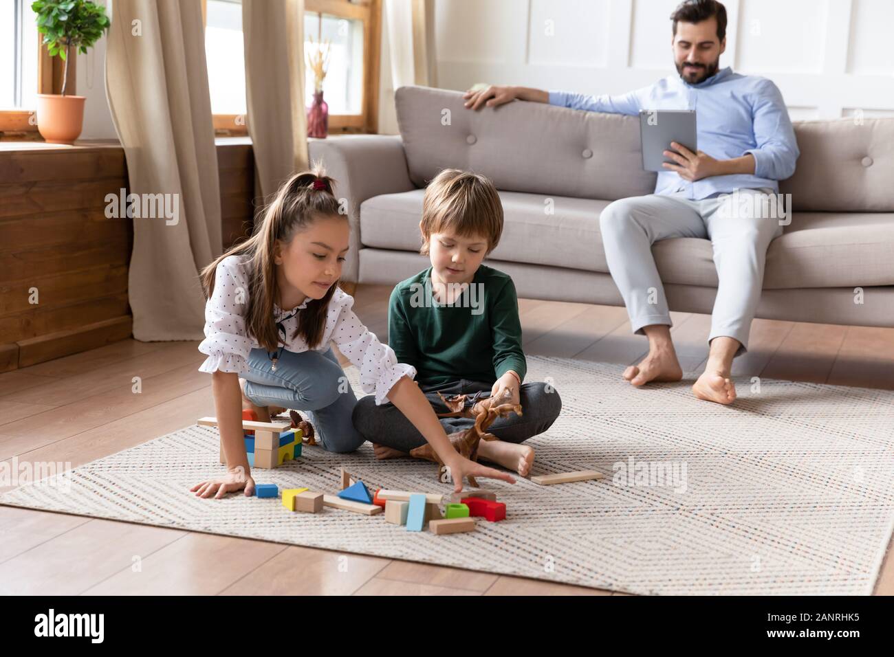 Happy kids play with bricks spend weekend with dad Stock Photo - Alamy