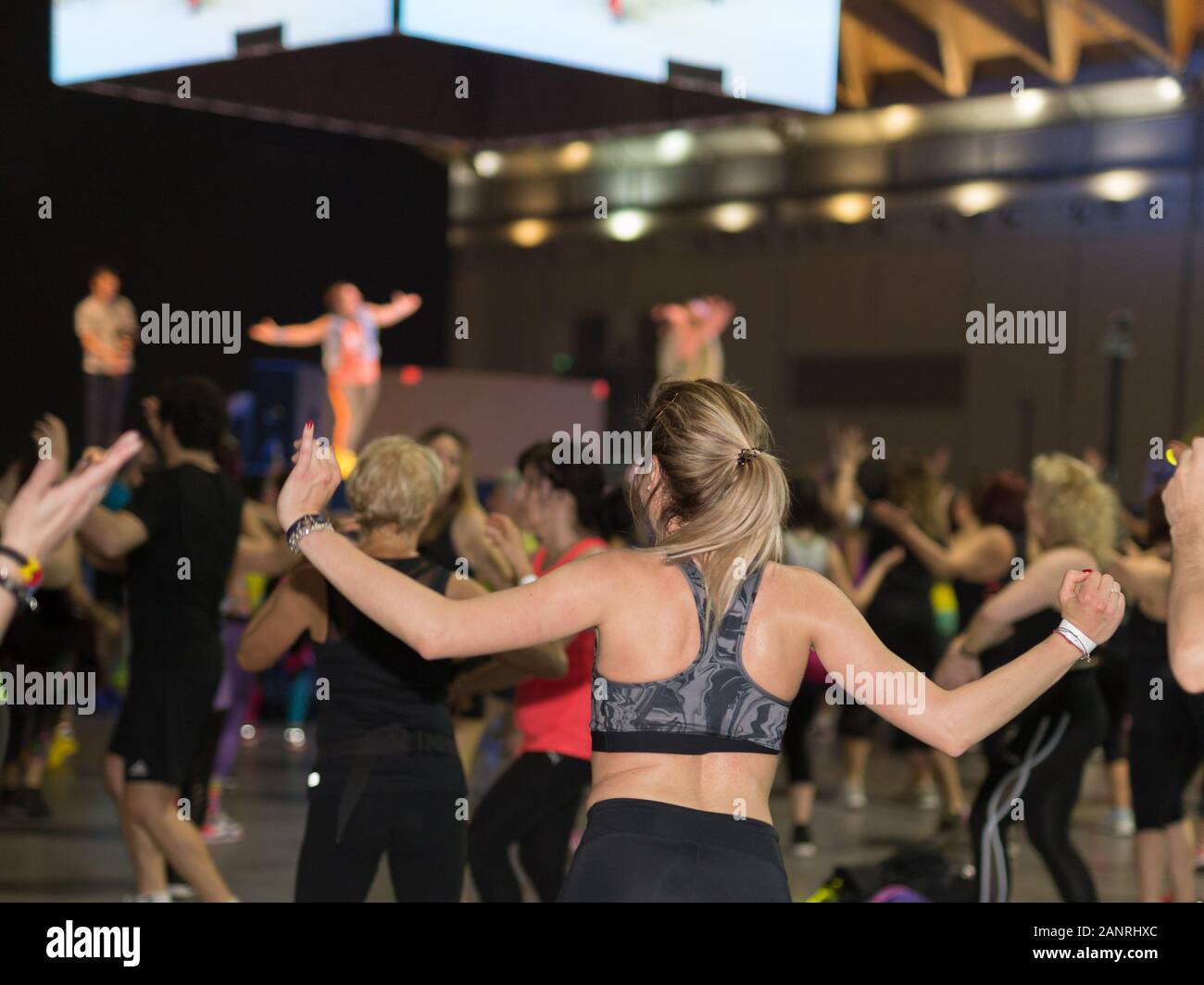 Fitness Workout in Gym: People doing Exercises in Class with Music and ...