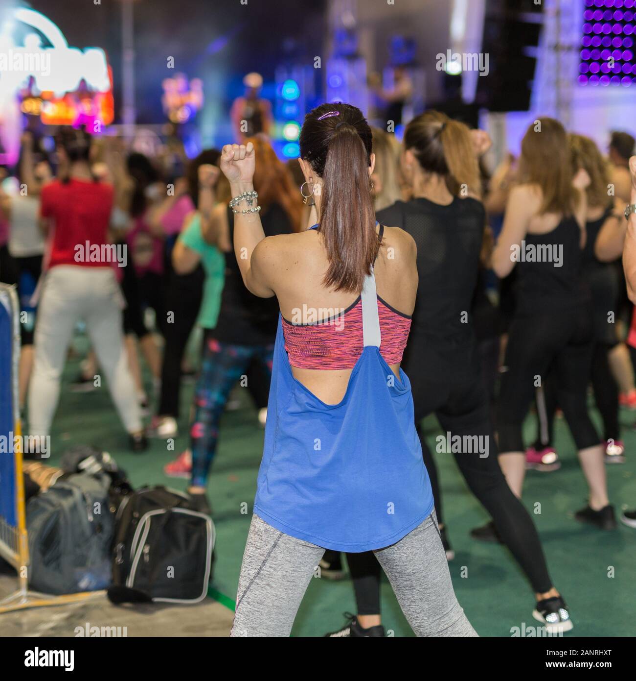 Fitness Workout in Gym: People doing Exercises in Class with Music and ...
