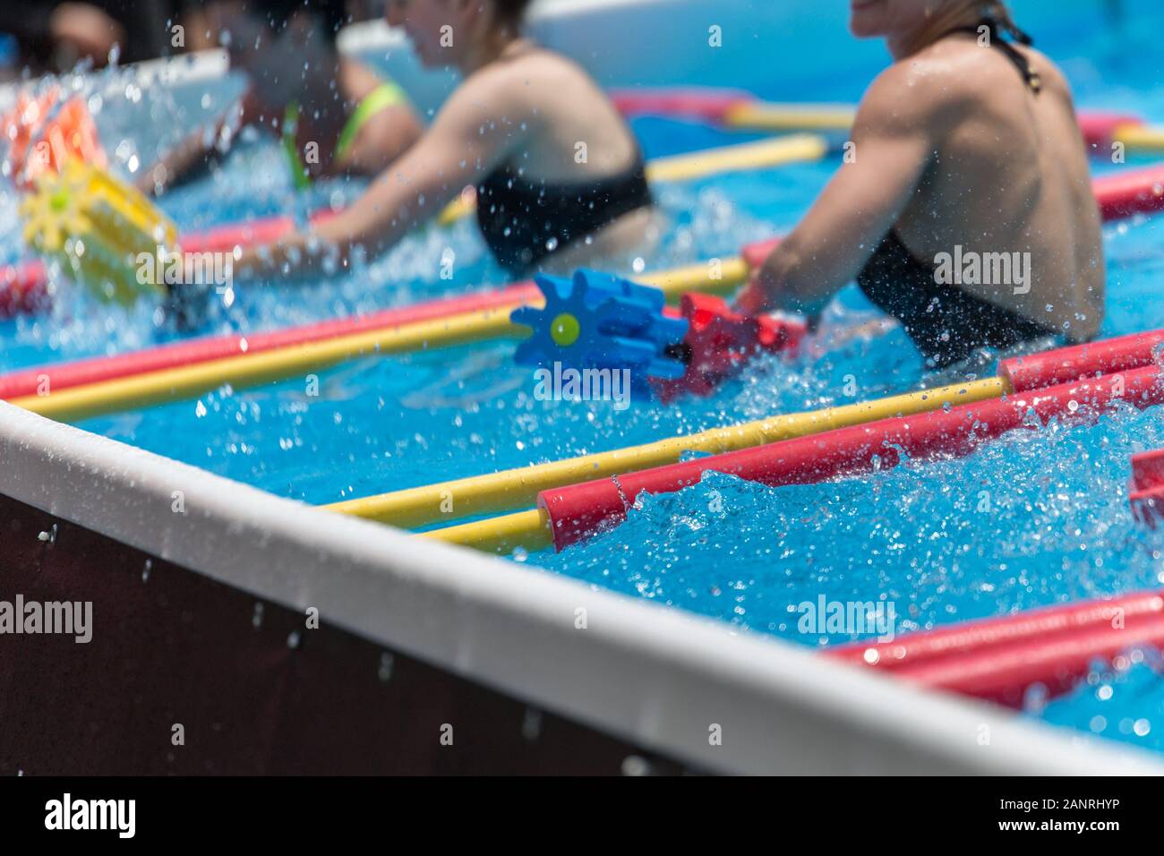 Girls Doing Water Aerobics with Floating Pool Dumbbells Outdoor in a ...