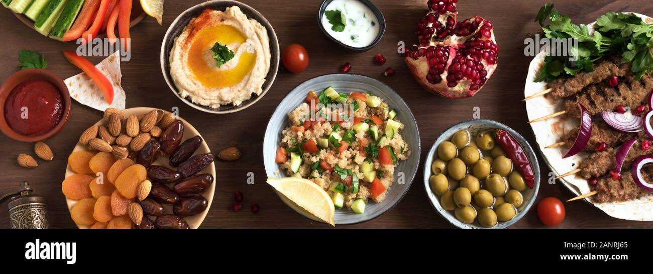 Middle Eastern Arabic food, dinner table. Meat kebab, hummus, tabbouleh ...