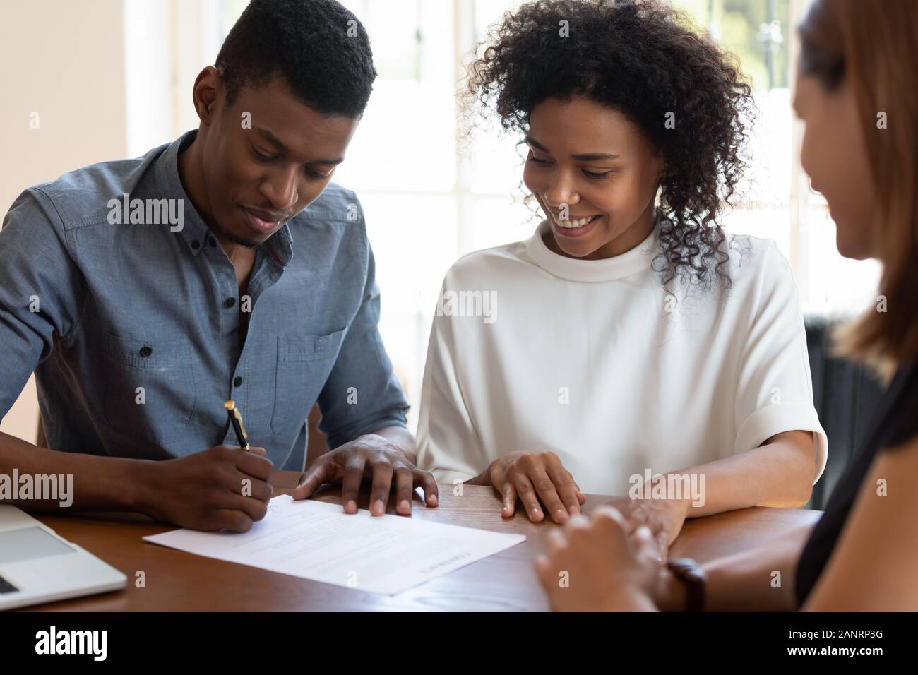 Happy African American couple signing contract, making deal Stock Photo ...