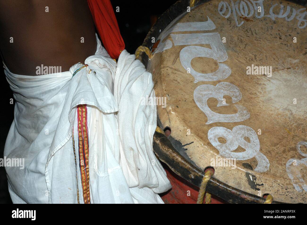 Theyyam, ritual dance, Musician playing drum with a Dothi. Kerala ...