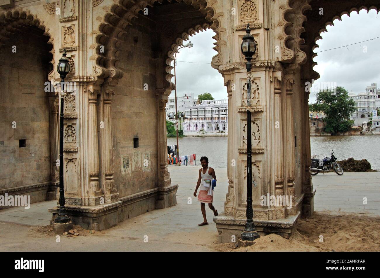 Udaipur, view, man walking after his bath in the lake. Rajasthan, India ...