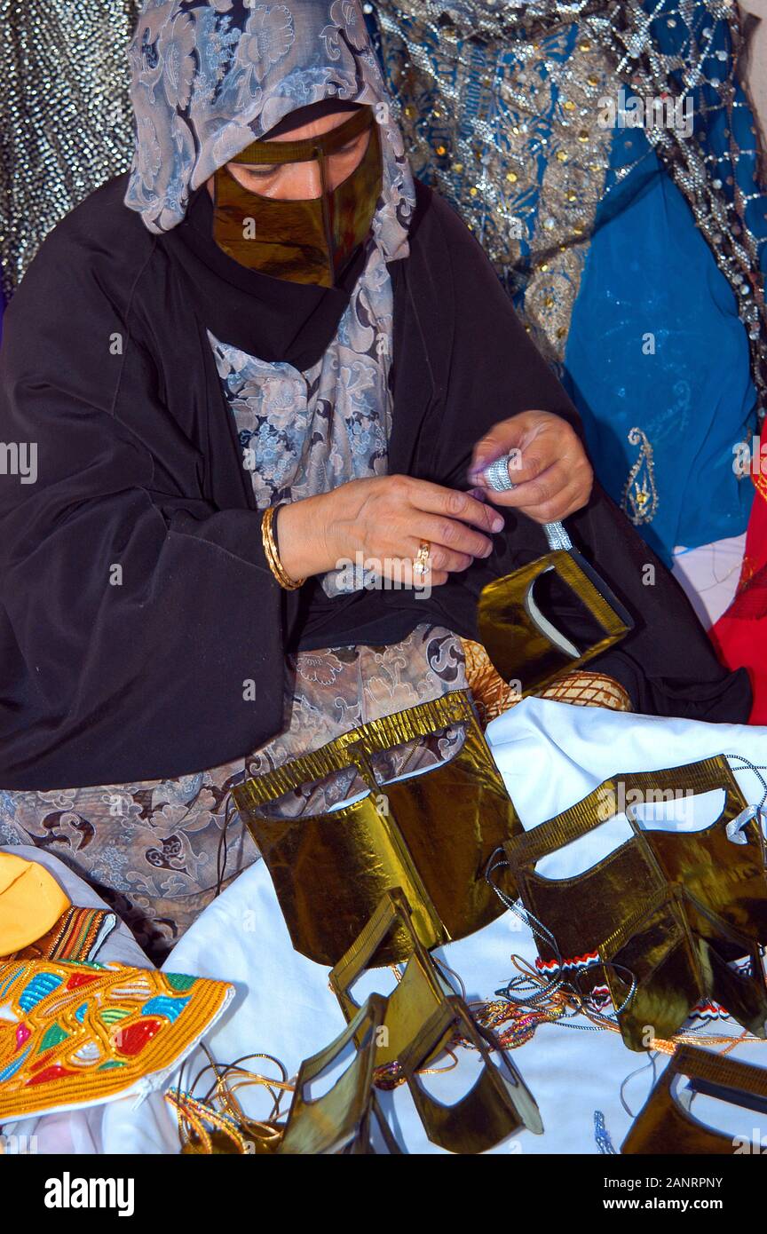 Qatari woman making Niqabs Stock Photo - Alamy