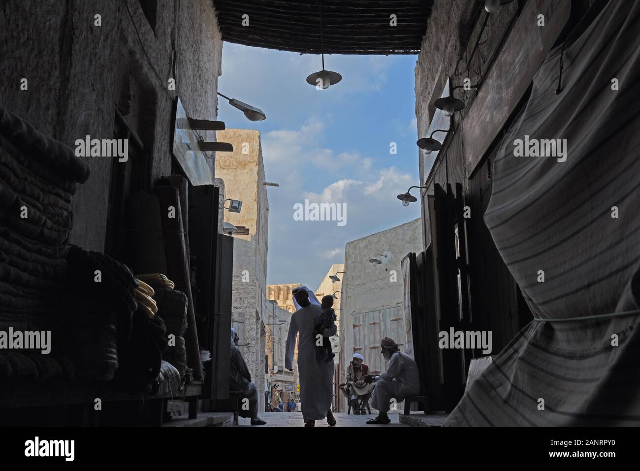 Doha, Qatar- Qatari man carrying a baby at Souq Waqif Stock Photo - Alamy