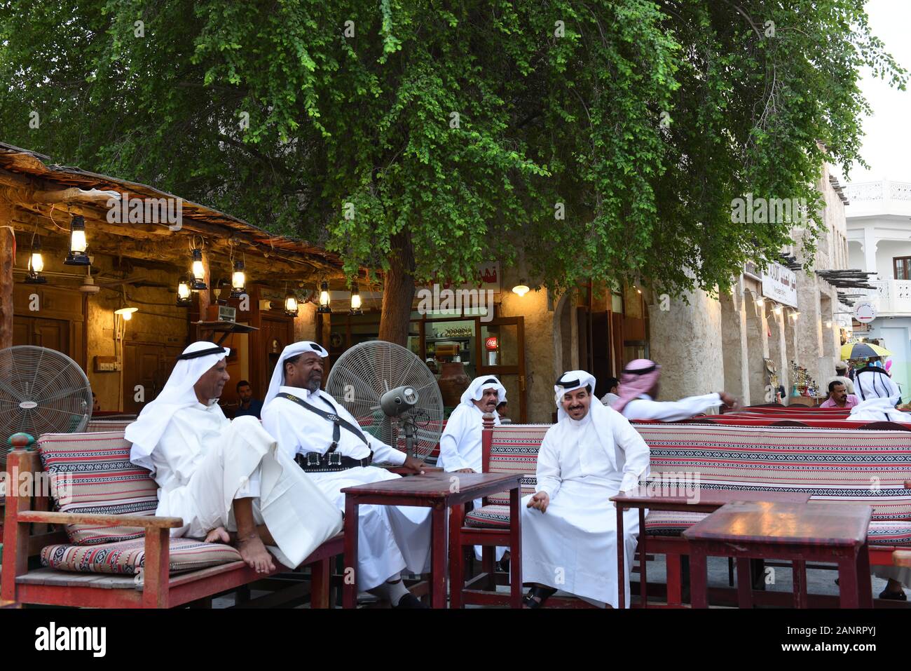 Doha, Qatar- group of Qatari men sitting in a coffee shop at Souq Waqif ...