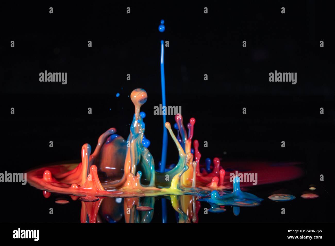 Color ink splash on a black background Stock Photo - Alamy