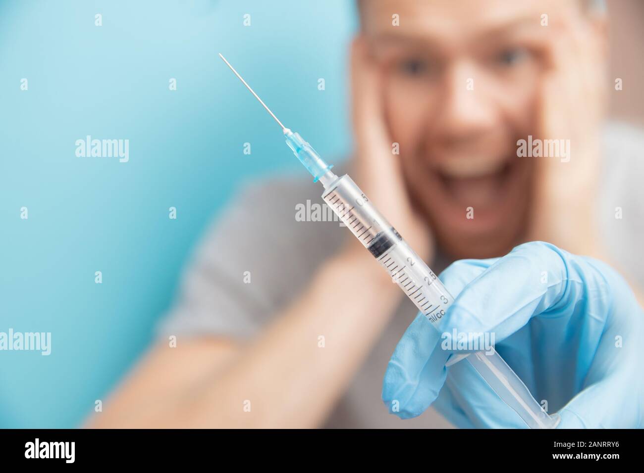 Man is afraid of nurse. Fear of syringe injections and vaccinations ...