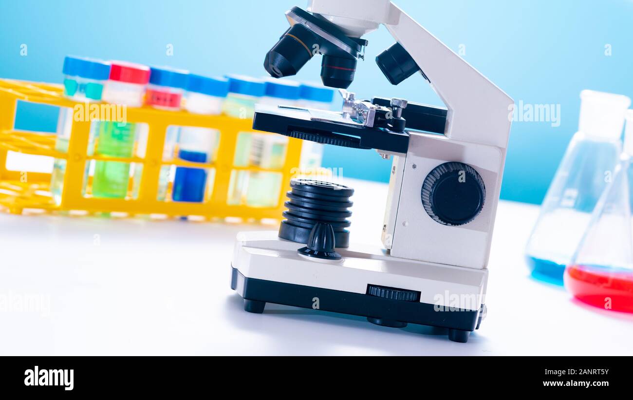 scientific experiment in school class. Microscope and test tubes on the ...