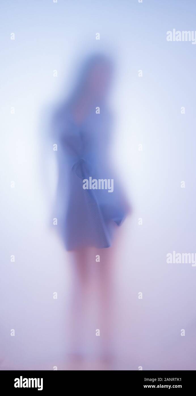 Blurred photo girl wearing dress dancing behind glass Stock Photo - Alamy