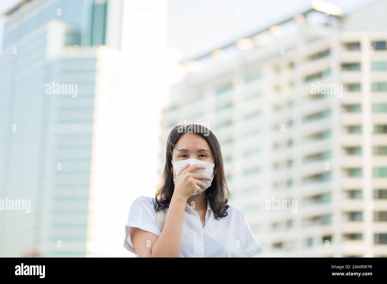Woman wearing face mask protect filter against air pollution (PM2.5) or ...