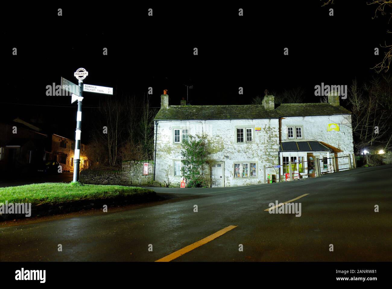 An old road sign and shop in the village of Malham in North Yorkshire ...