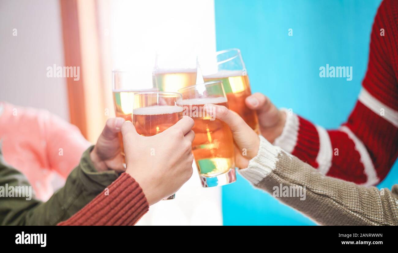 Group of friends cheering with beers in pub restaurant - Hands view of ...