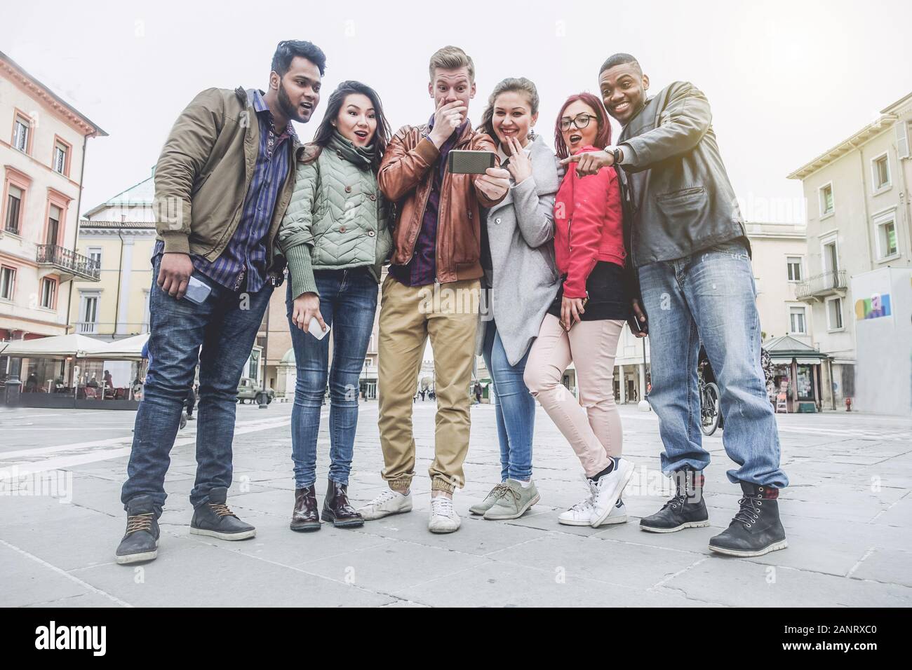 Multiracial group of people looking surprised smart phone - Young mixed ...