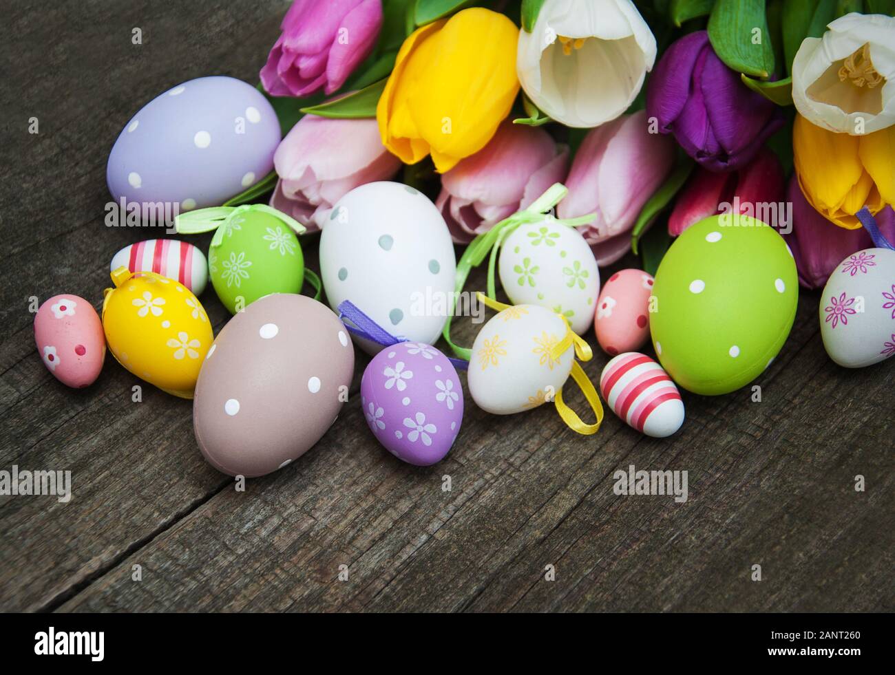 Easter eggs and tulips on a old wooden background Stock Photo - Alamy