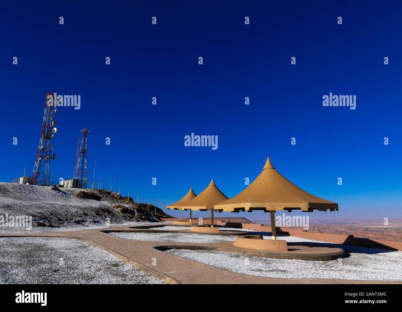 Cellular transmission towers and umbrellas at the top of a hill, Al ...