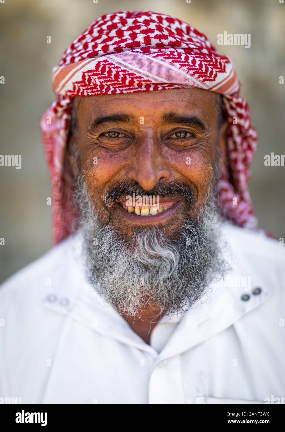 Portrait of a smiling saudi man wearing a keffiyeh, Jizan province ...