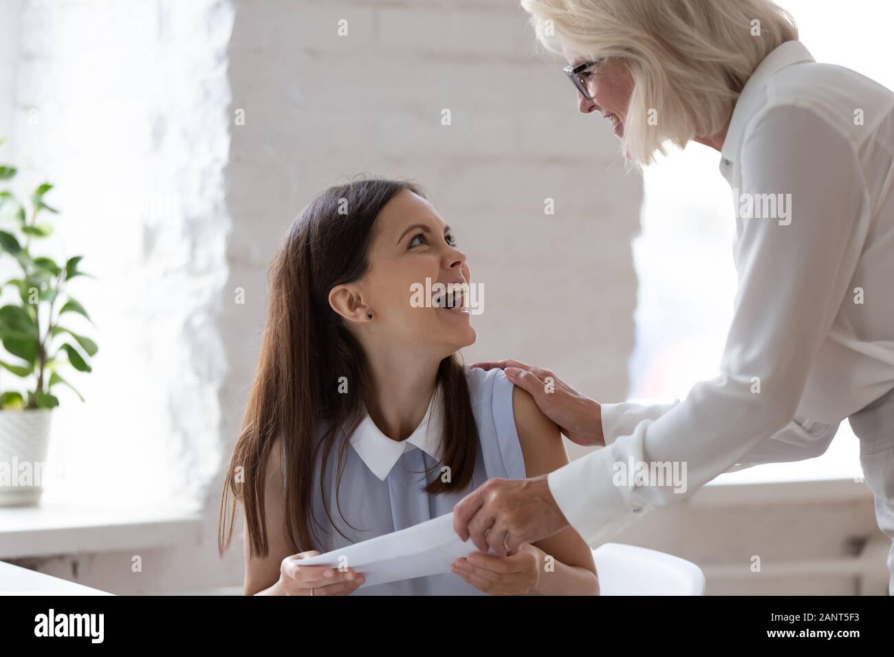 Grateful boss giving monetary reward to employee for great work Stock ...