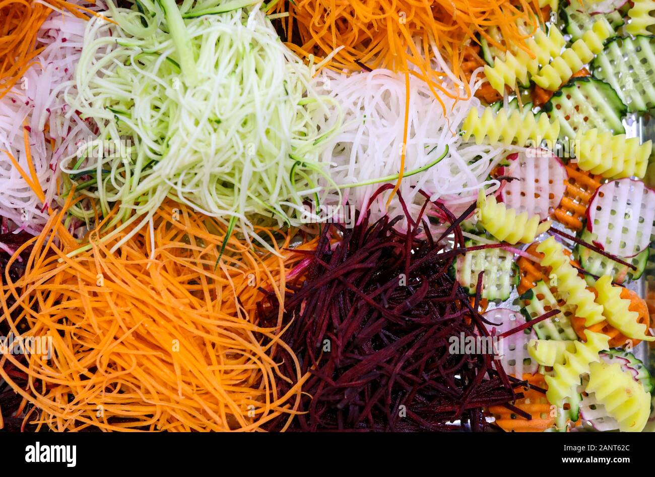 Different raw shredded vegetables and fruits as an example of a healthy ...