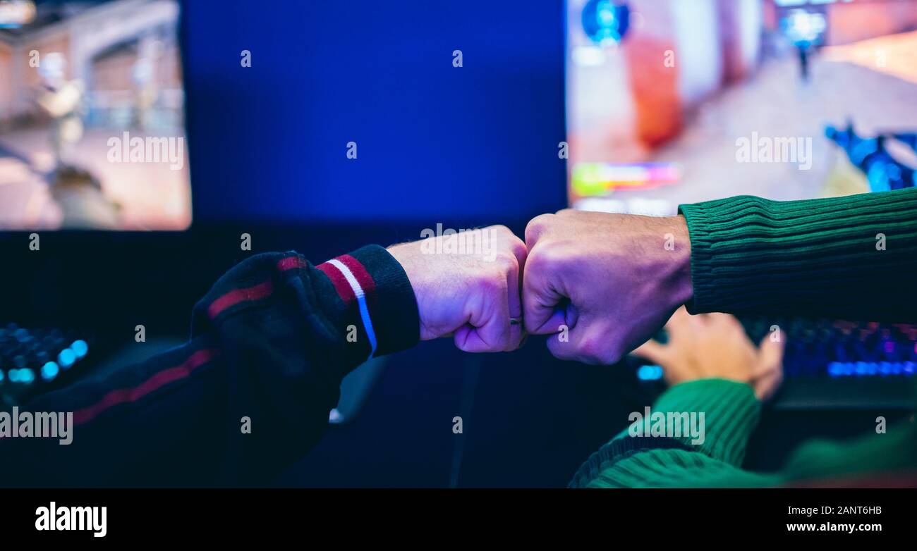 Professional gamer greeting and support team fists hands online game in ...