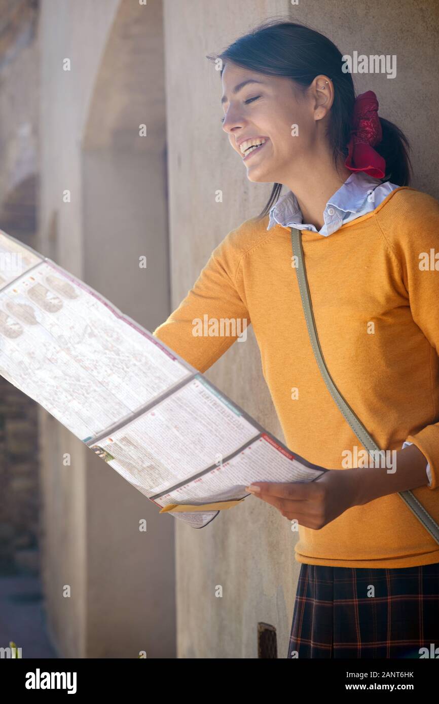 Smiling tourist woman using map as guide on vacation. closeup Stock ...