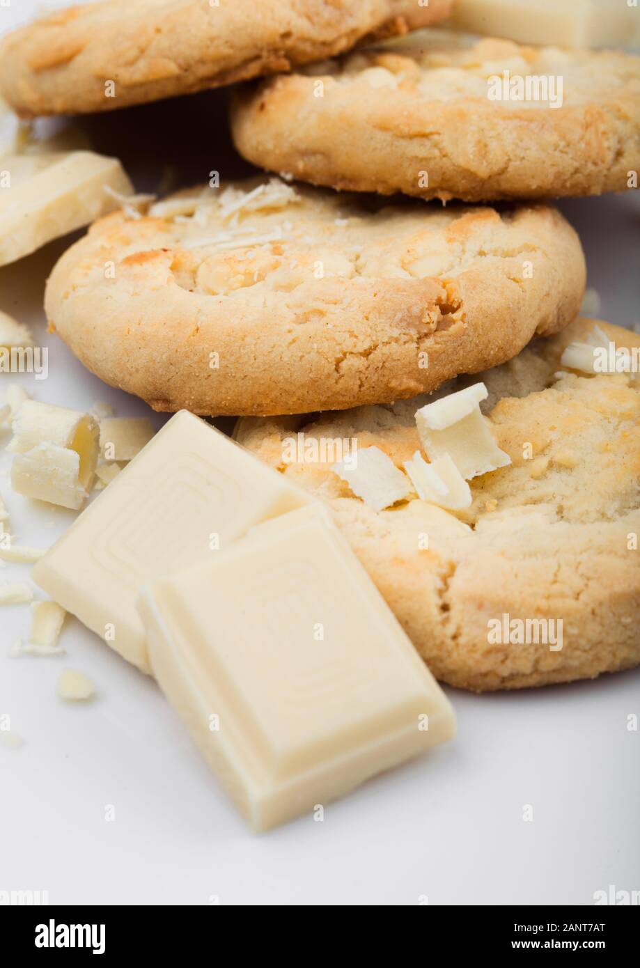 White chocolate biscuit cookies with chocolate blocks and curls on ...