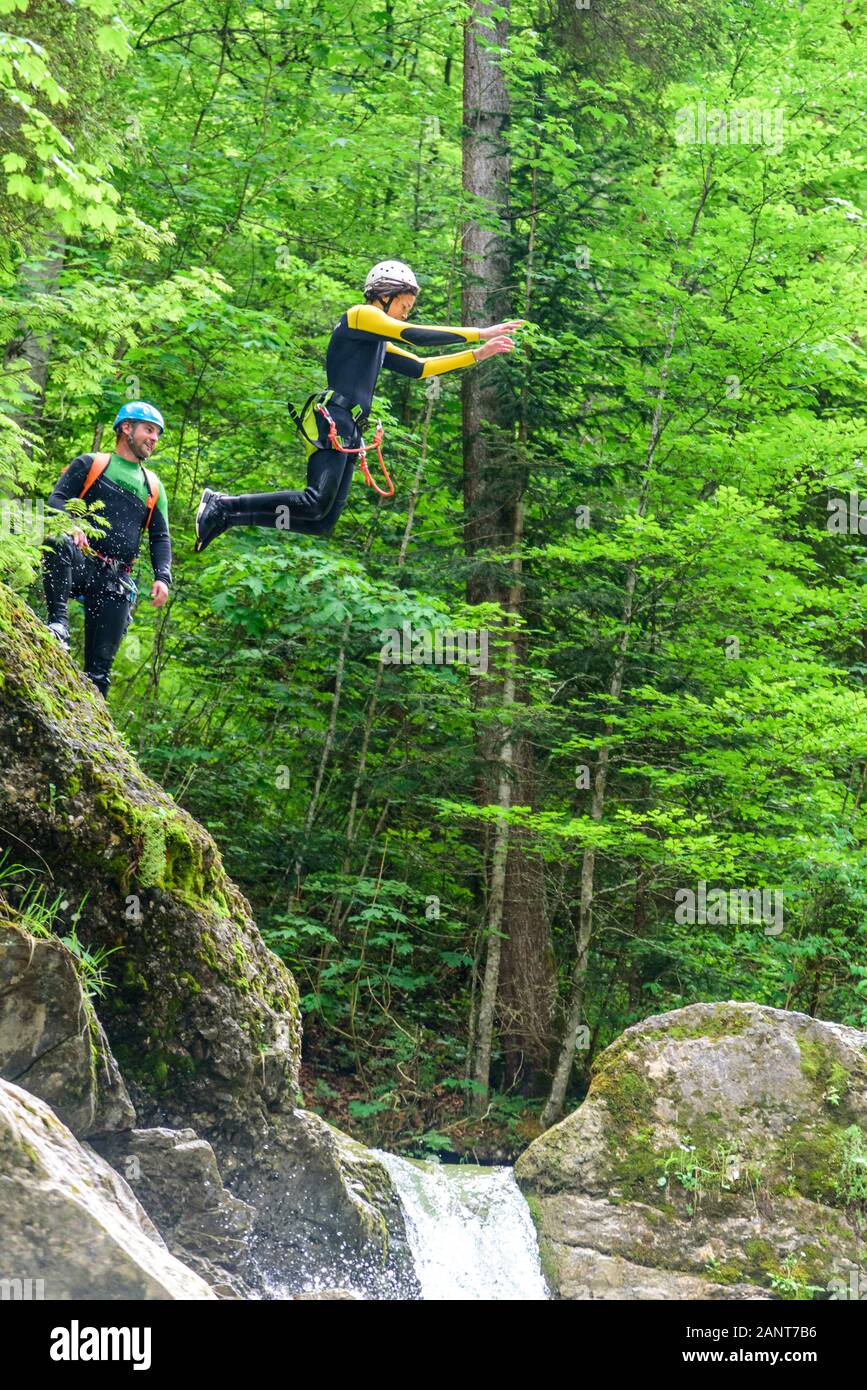 A group of adventurers doing a canyoning tour in the impressive nature ...