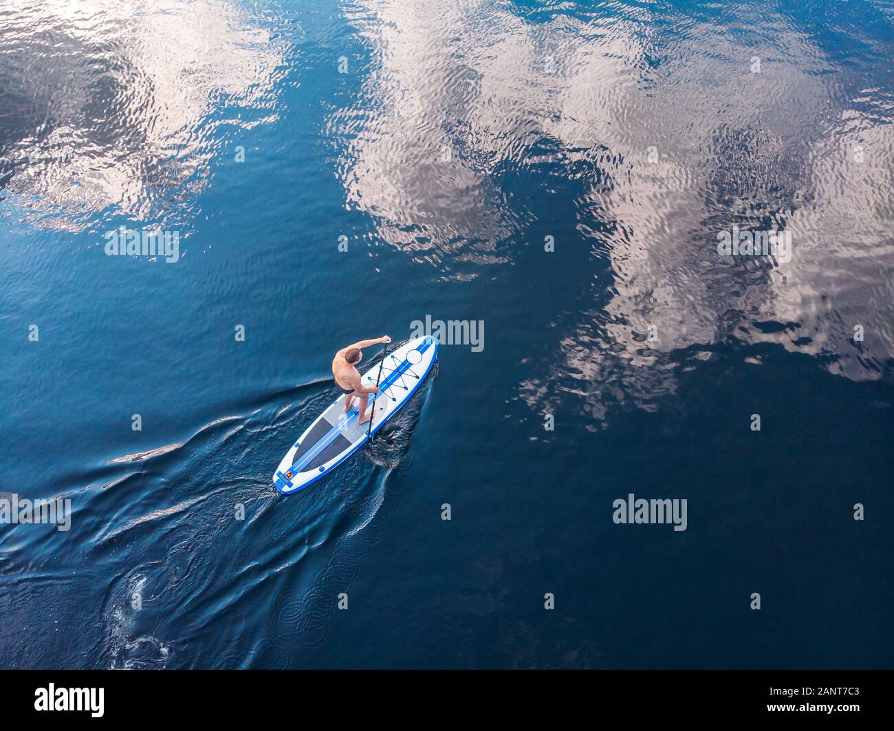 Paddle boarding lying on board hi-res stock photography and images - Alamy